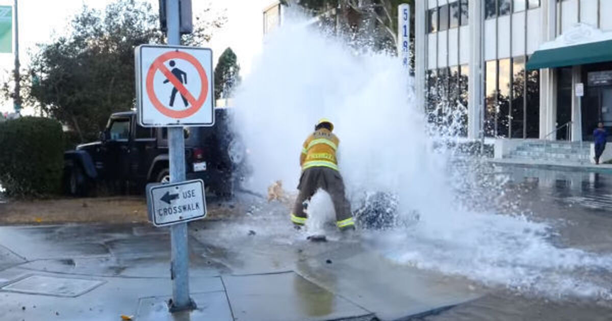 Watch a fireman shut off a fire hydrant after it was hit by a jeep