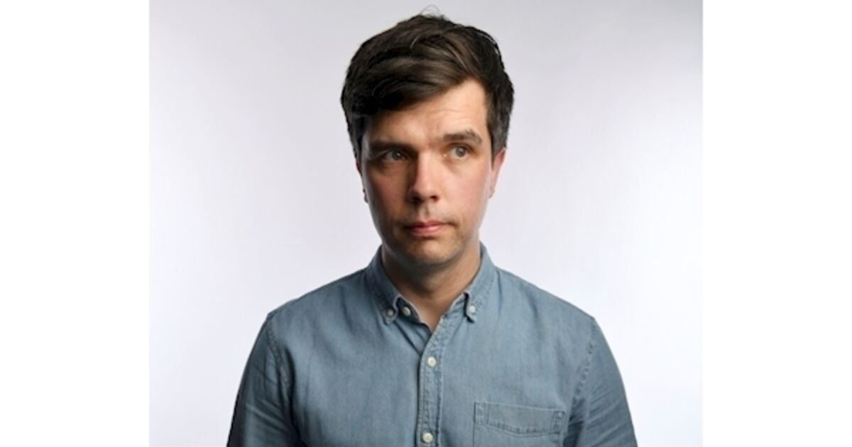Comedian Chris Kent taking his electrician past on stage