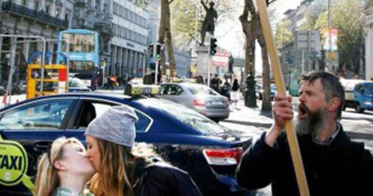This photo of a defiant kiss in front of a No protestor is going viral
