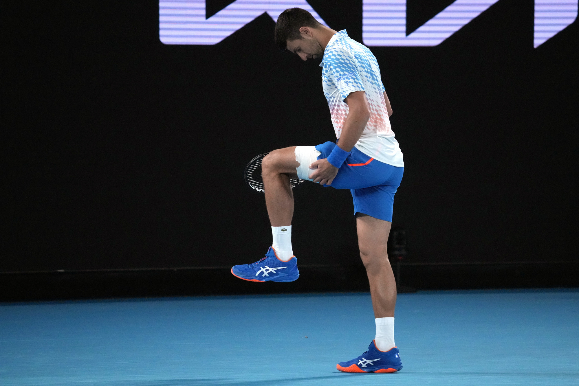 Djokovic taking hamstring injury ‘day to day’ as he progresses in Melbourne