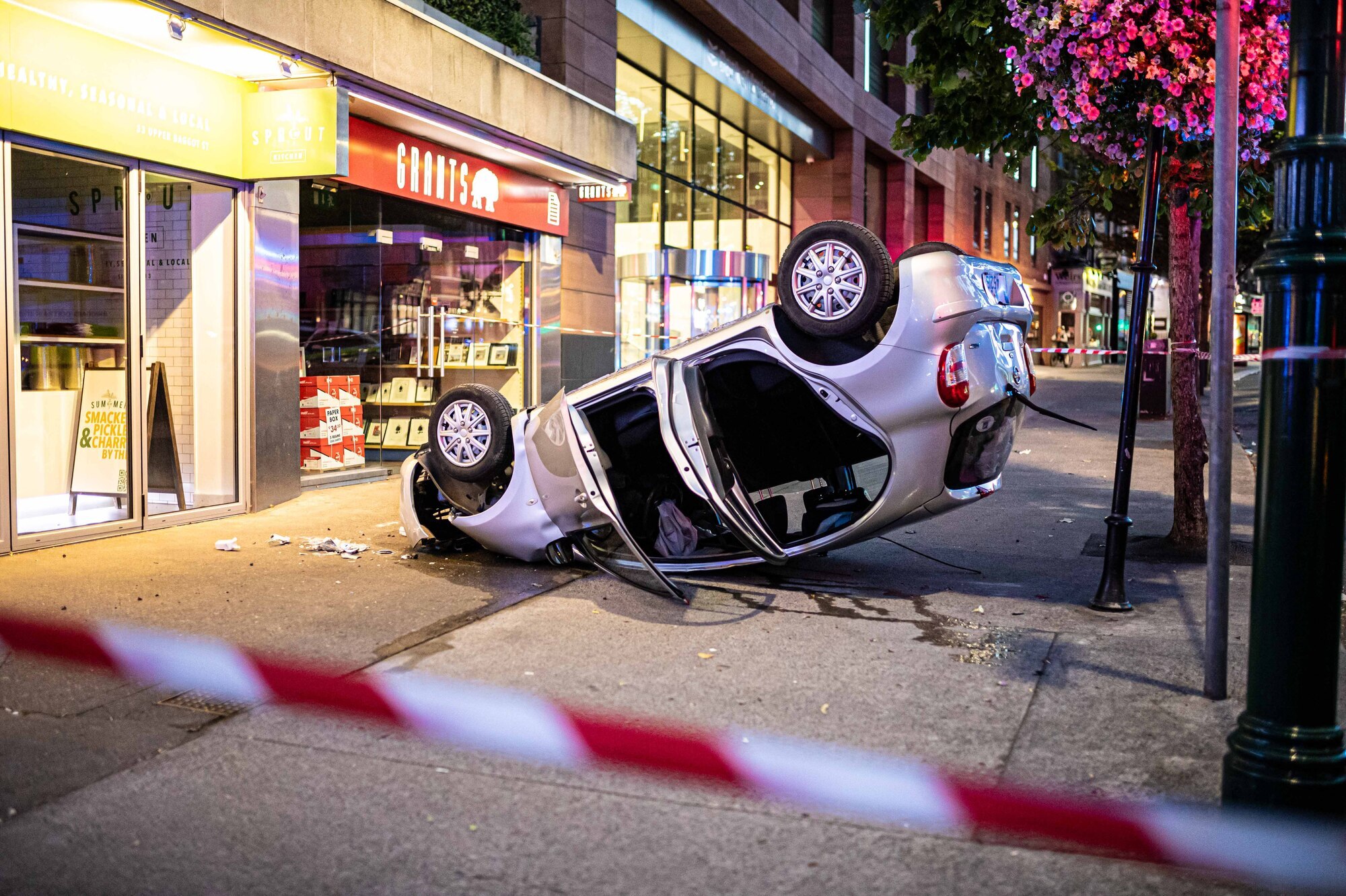 Two escape without injury after car falls from multi-storey car park