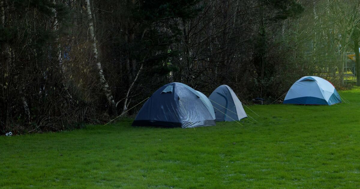 People living in tents next to building for international applicants in ...
