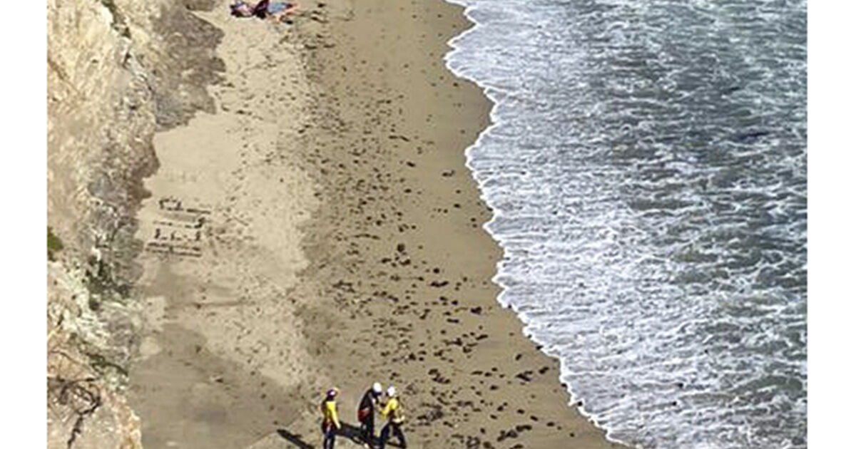 Kite surfer rescued from remote US beach after making ‘help’ sign with ...