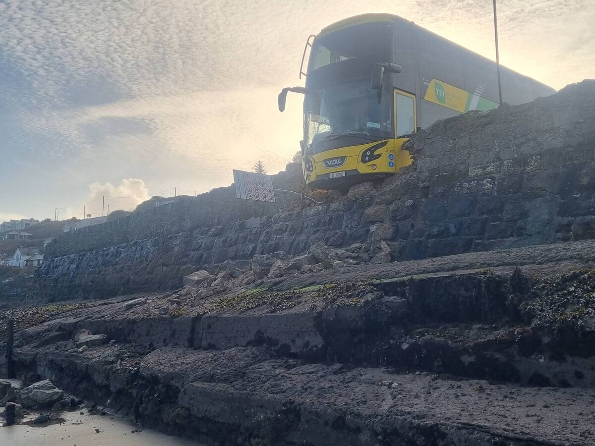Double decker bus crashes through sea wall after driver parks it at ...